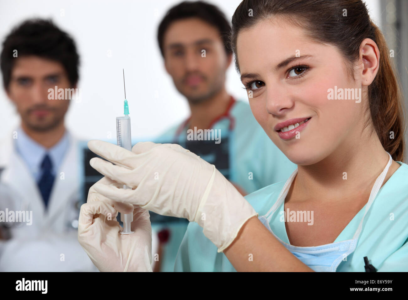 Nurse holding needle Stock Photo - Alamy