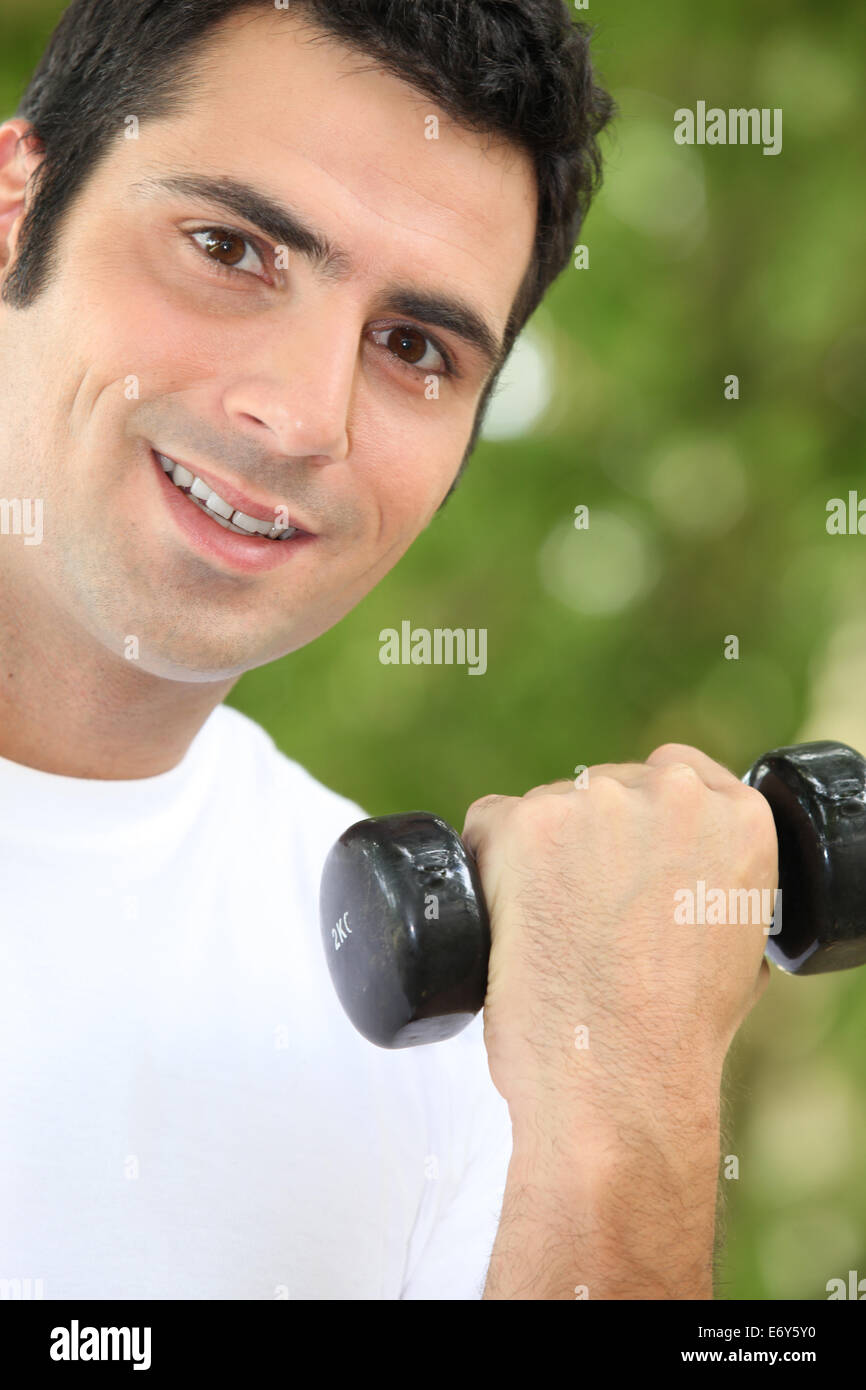 Man lifting light weights Stock Photo - Alamy