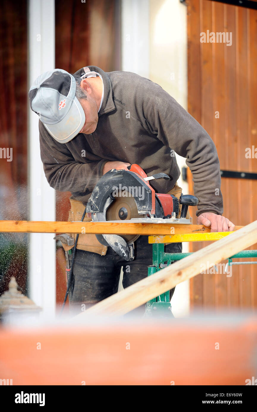 Man using circular saw on construction site Stock Photo - Alamy