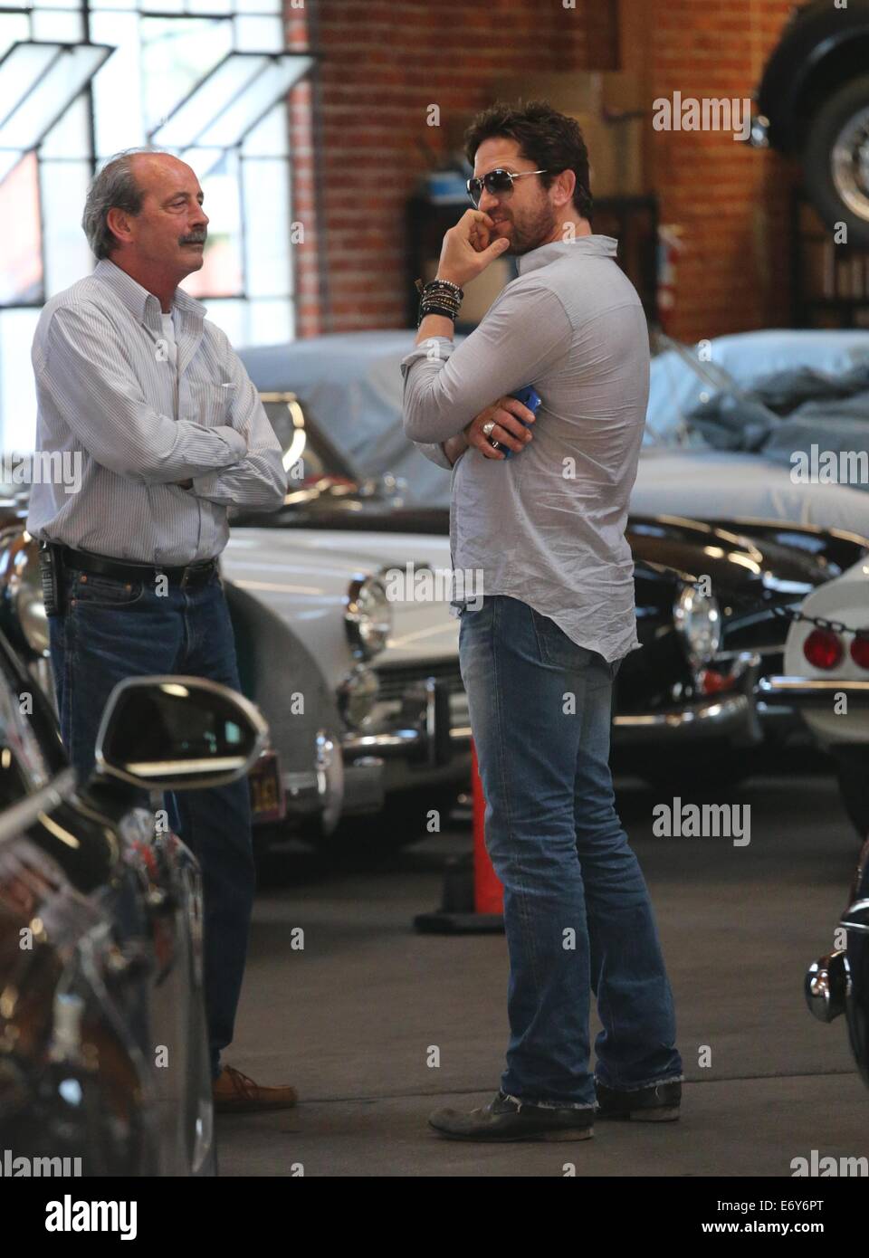 Gerard Butler looks at classic antique automobiles at Heritage Classic ...