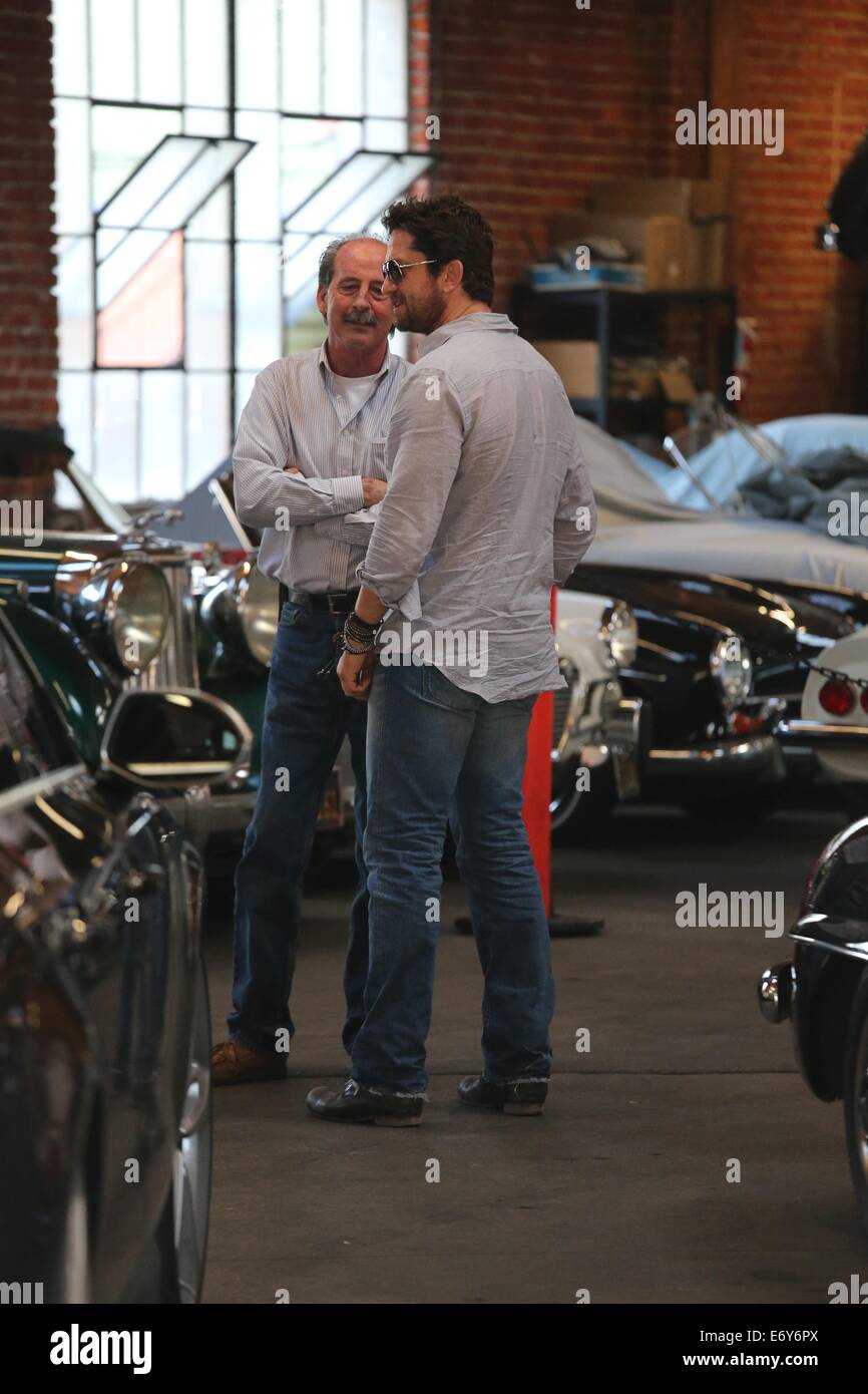Gerard Butler looks at classic antique automobiles at Heritage Classic ...