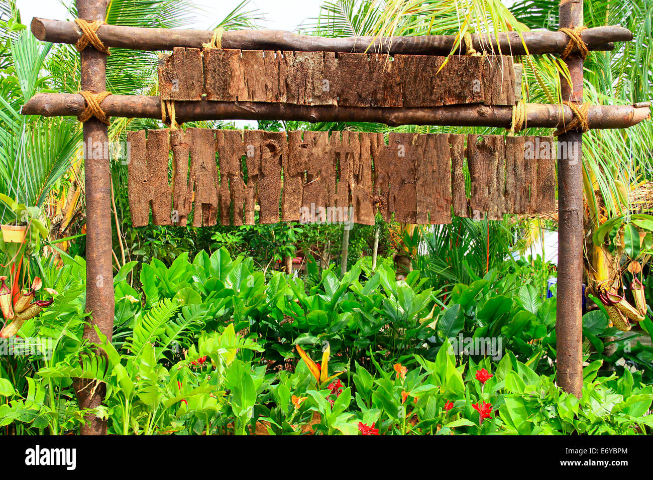 Wooden signboard among green plantation Stock Photo - Alamy