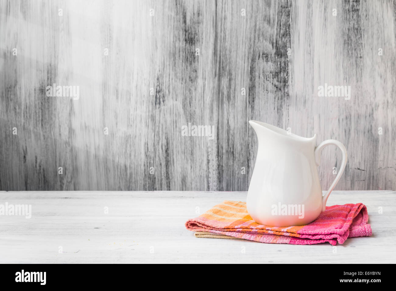 Still life with white jug on kitchen cloth Stock Photo - Alamy