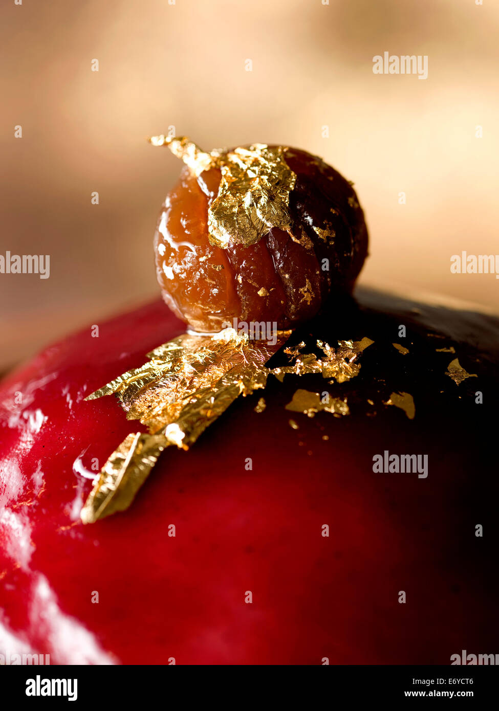 Candied chestnut coated in golden leaves Stock Photo - Alamy