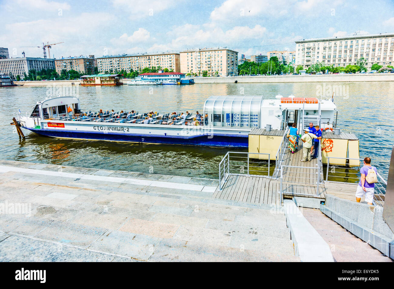 Passengers going aboard small leisure boat on the berth of Moscow Gorky ...