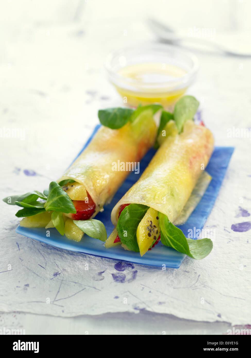 Pineapple spring rolls with fresh fruit and watercress filling Stock ...