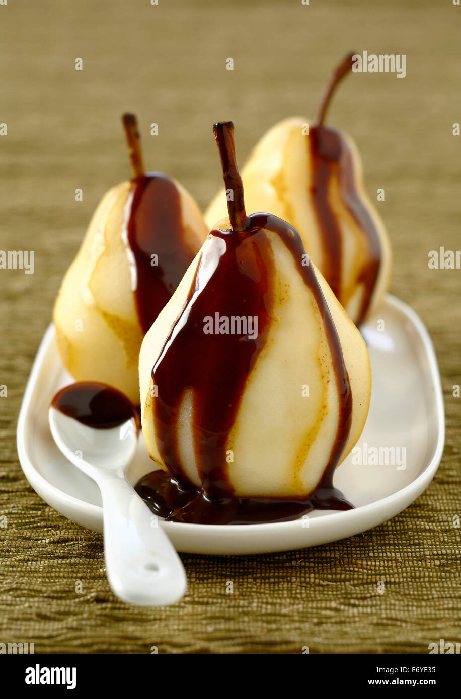 Poached pears with green tea-flavored melted chocolate Stock Photo - Alamy