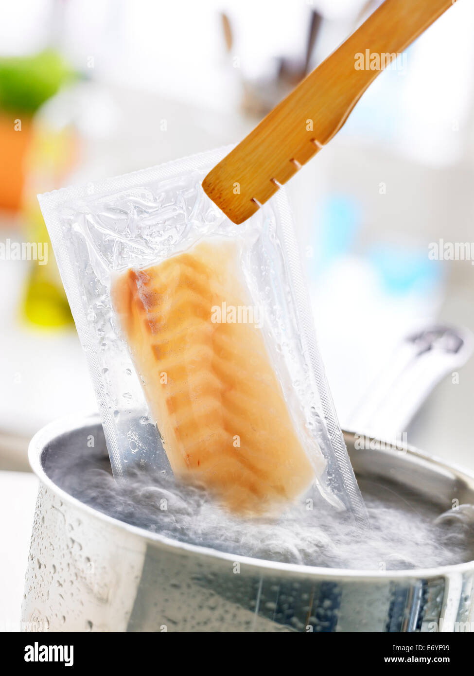 Vacuum packed piece of cod cooking in boiling water Stock Photo - Alamy
