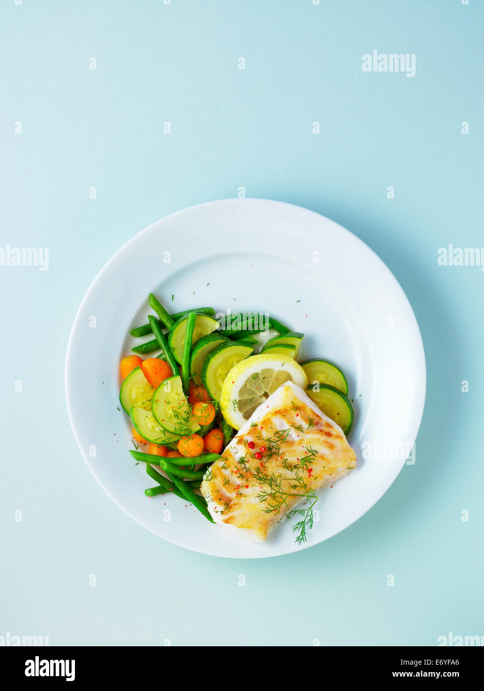 Piece of cod with vegetables and dill Stock Photo - Alamy
