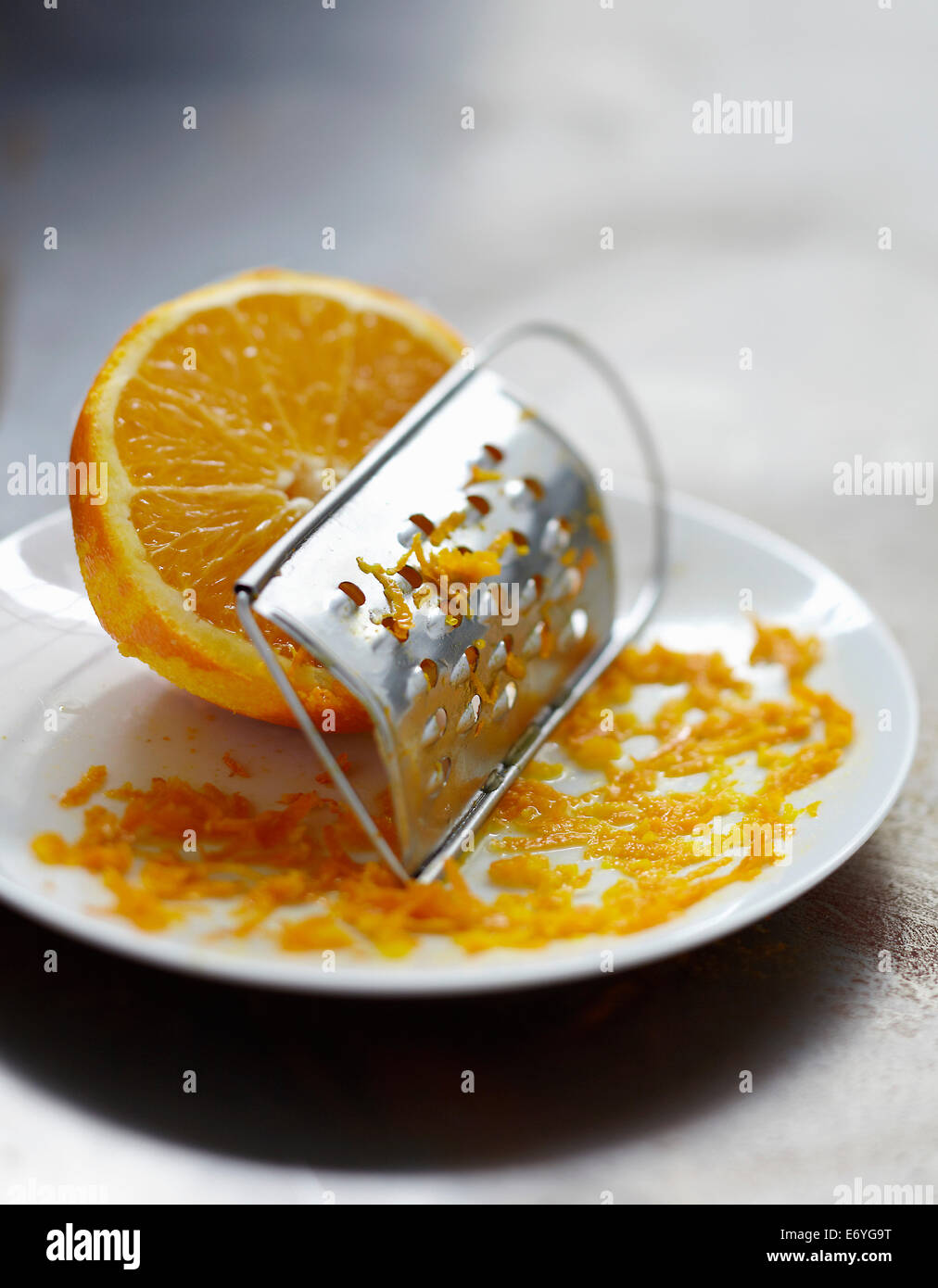 Grating orange zests Stock Photo - Alamy