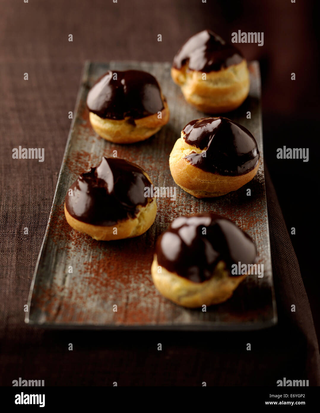 Puff pastries coated in dark chocolate Stock Photo - Alamy