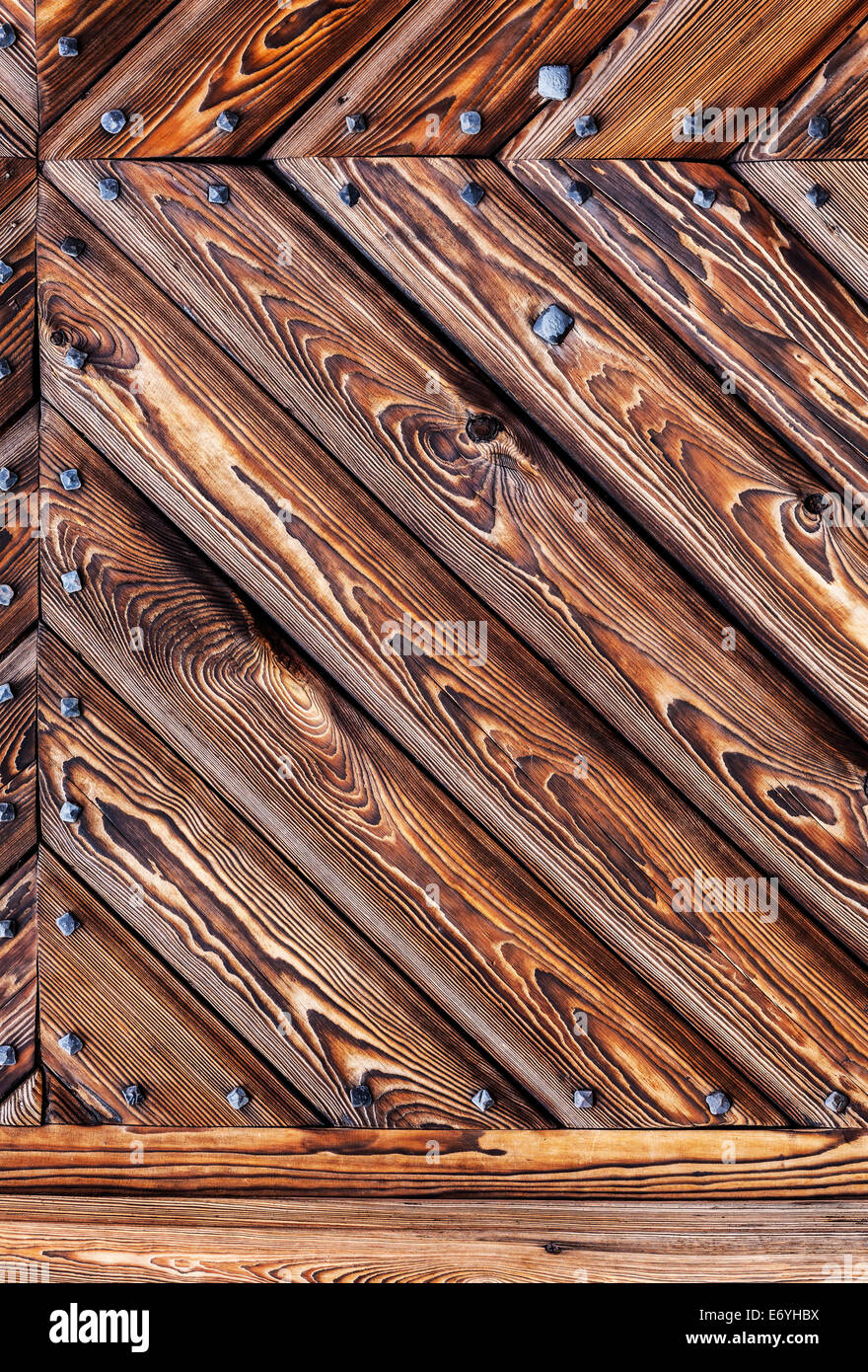 Wooden background with metal rivets, old gate of castle Stock Photo - Alamy