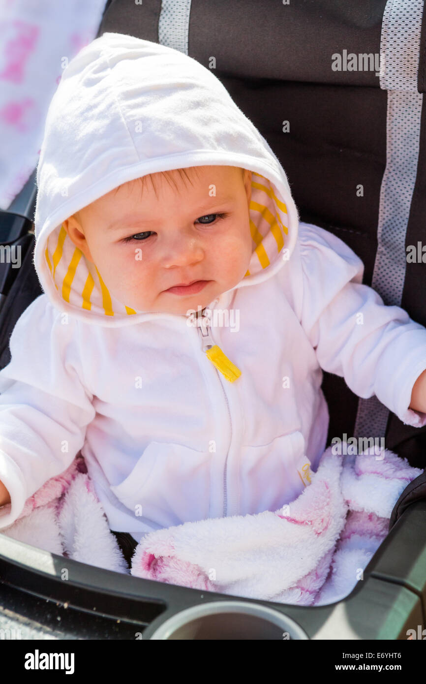 Cute baby girl sitting in the striller Stock Photo - Alamy