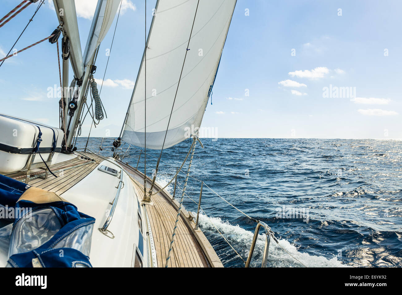 Sailing boat deck with hoisted sails and teak deck Stock Photo - Alamy