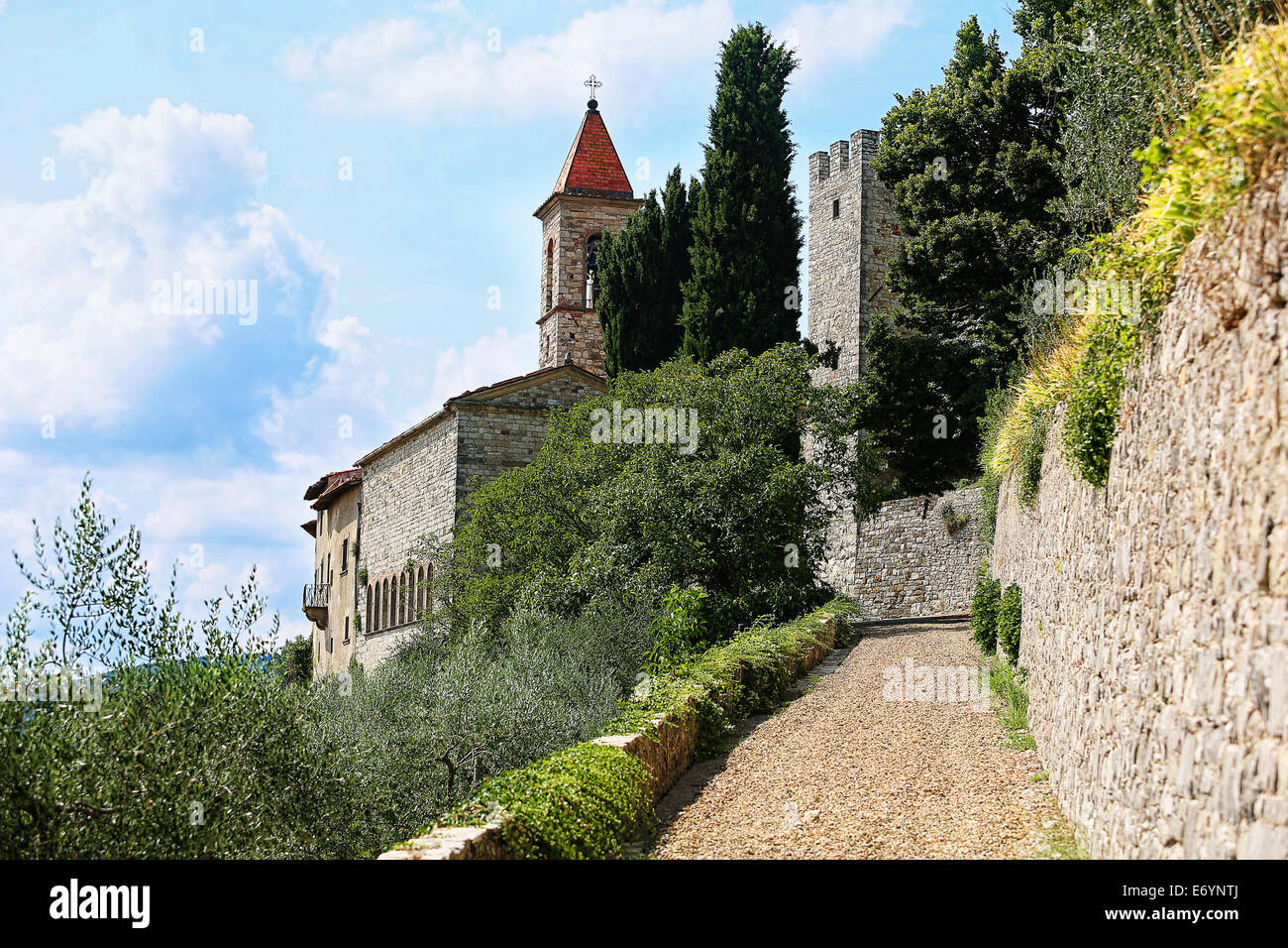 Road to the Castello Nipozzano with fortress and the church spire ...