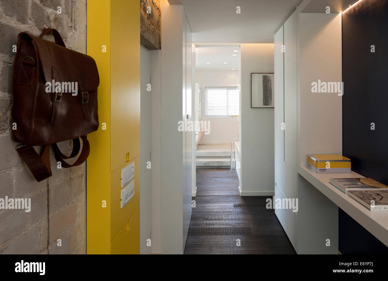 Brown leather satchel hanging in hallway of Amir Navon House, Israel ...