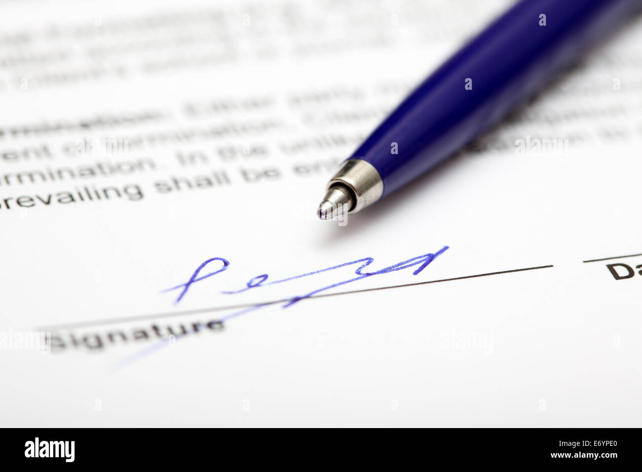 Signed contract or document. Ballpoint pen resting on contract. Focus ...