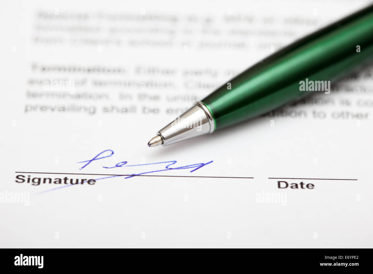 Signed contract or document. Ballpoint pen resting on contract. Focus ...