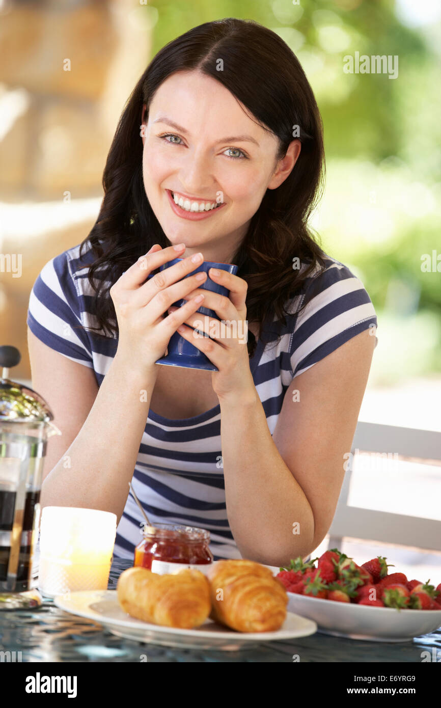 Woman eating breakfast outdoors Stock Photo - Alamy