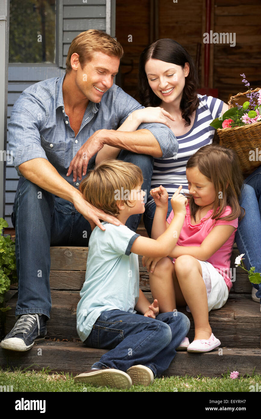 Family sitting on veranda Stock Photo - Alamy