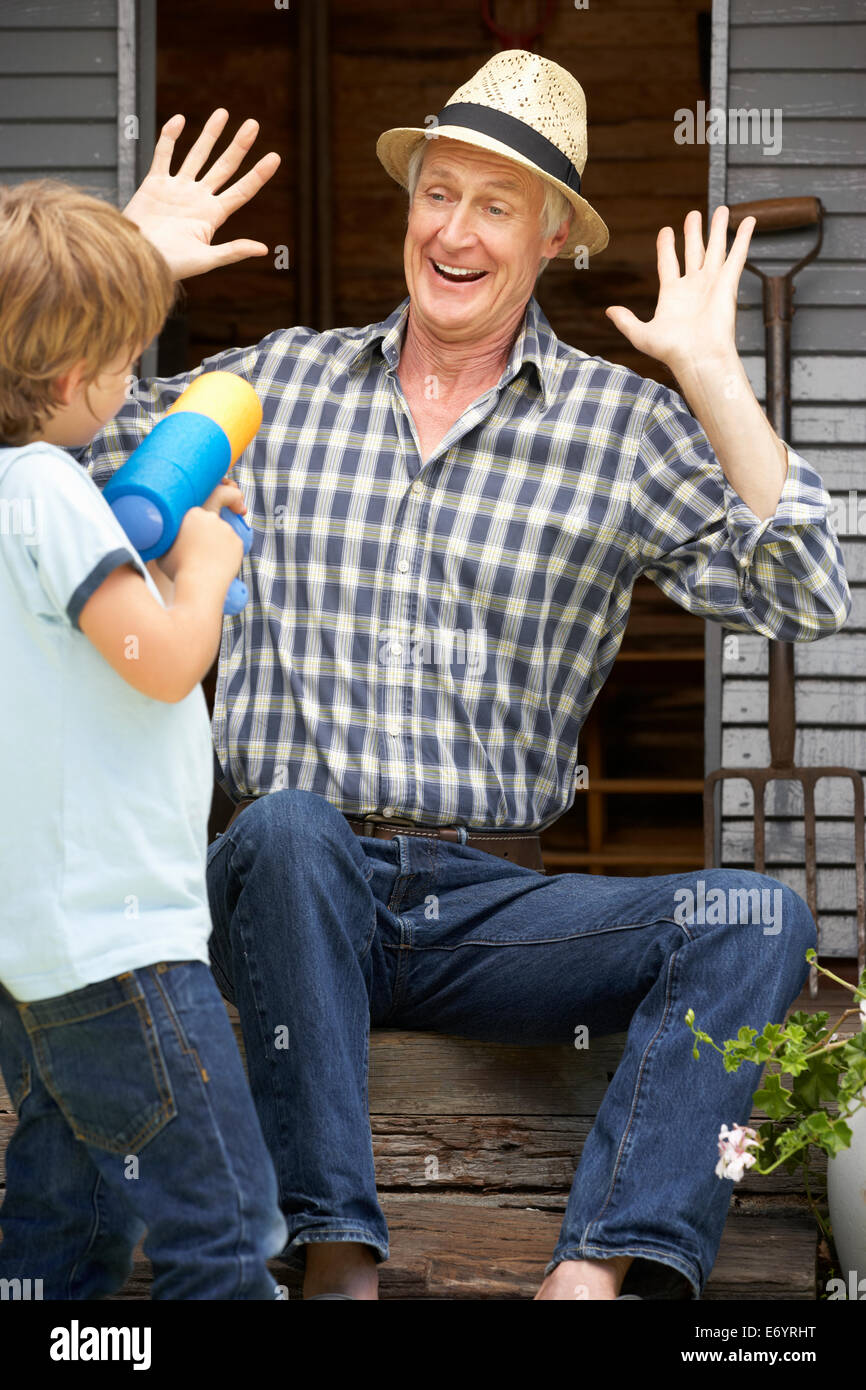 Grandfather and grandson playing in garden Stock Photo - Alamy