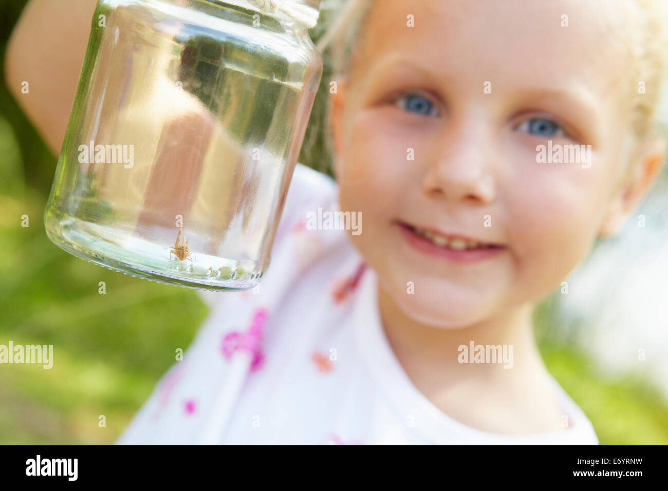 Little girl with cricket in a jar Stock Photo - Alamy