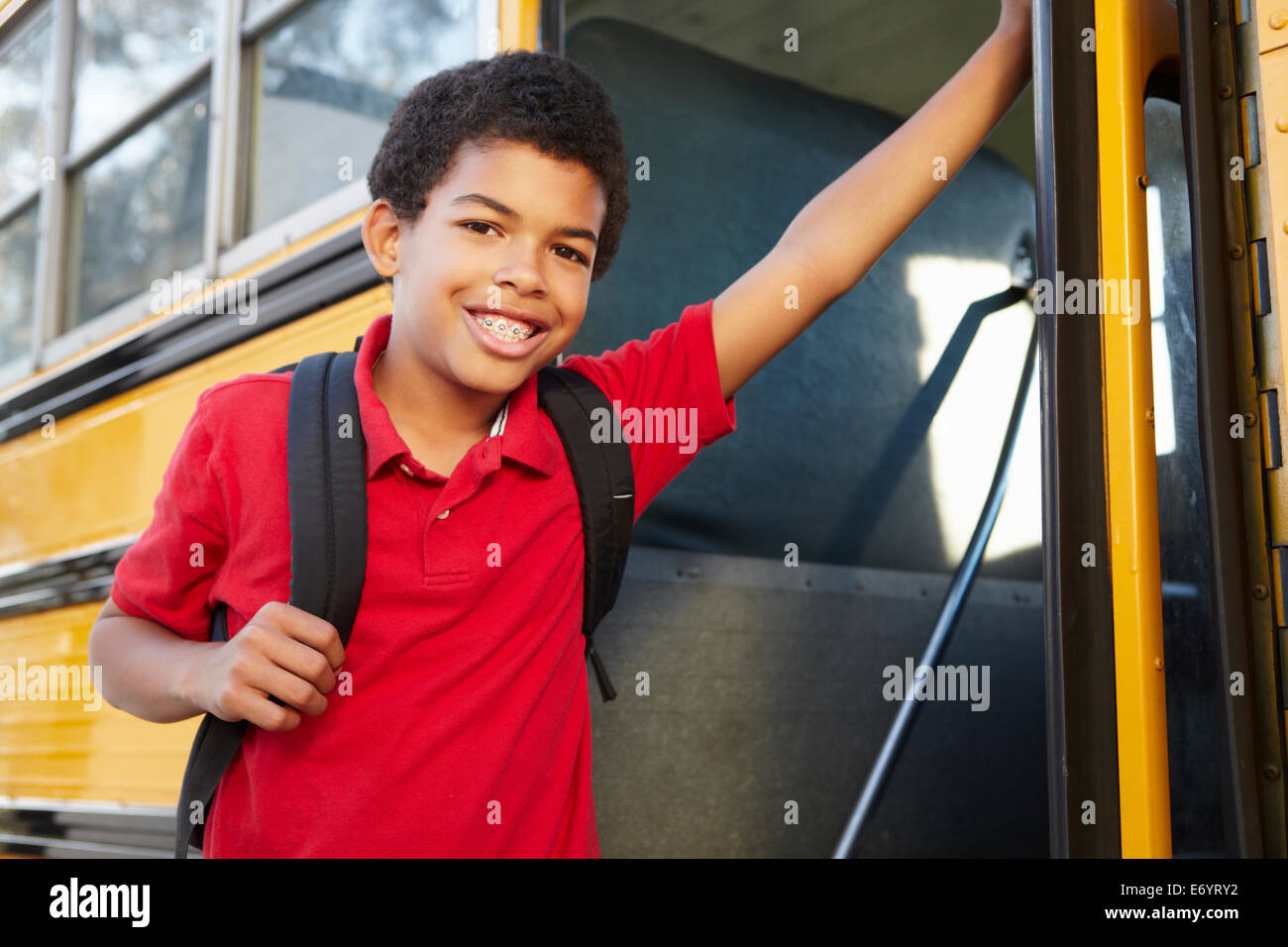Pre teen boy getting on school bus Stock Photo - Alamy