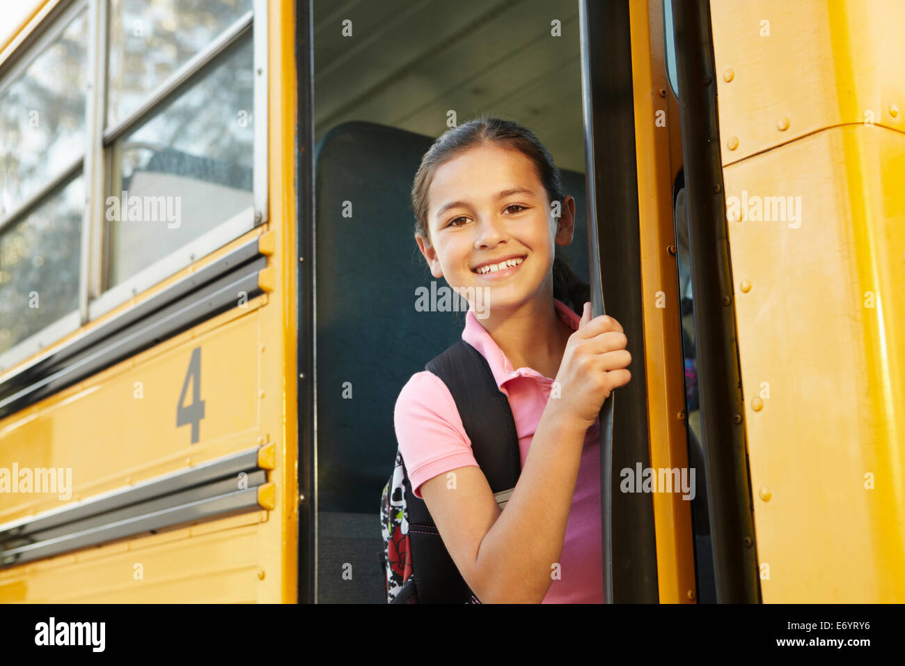 Pre teen girl getting on school bus Stock Photo - Alamy