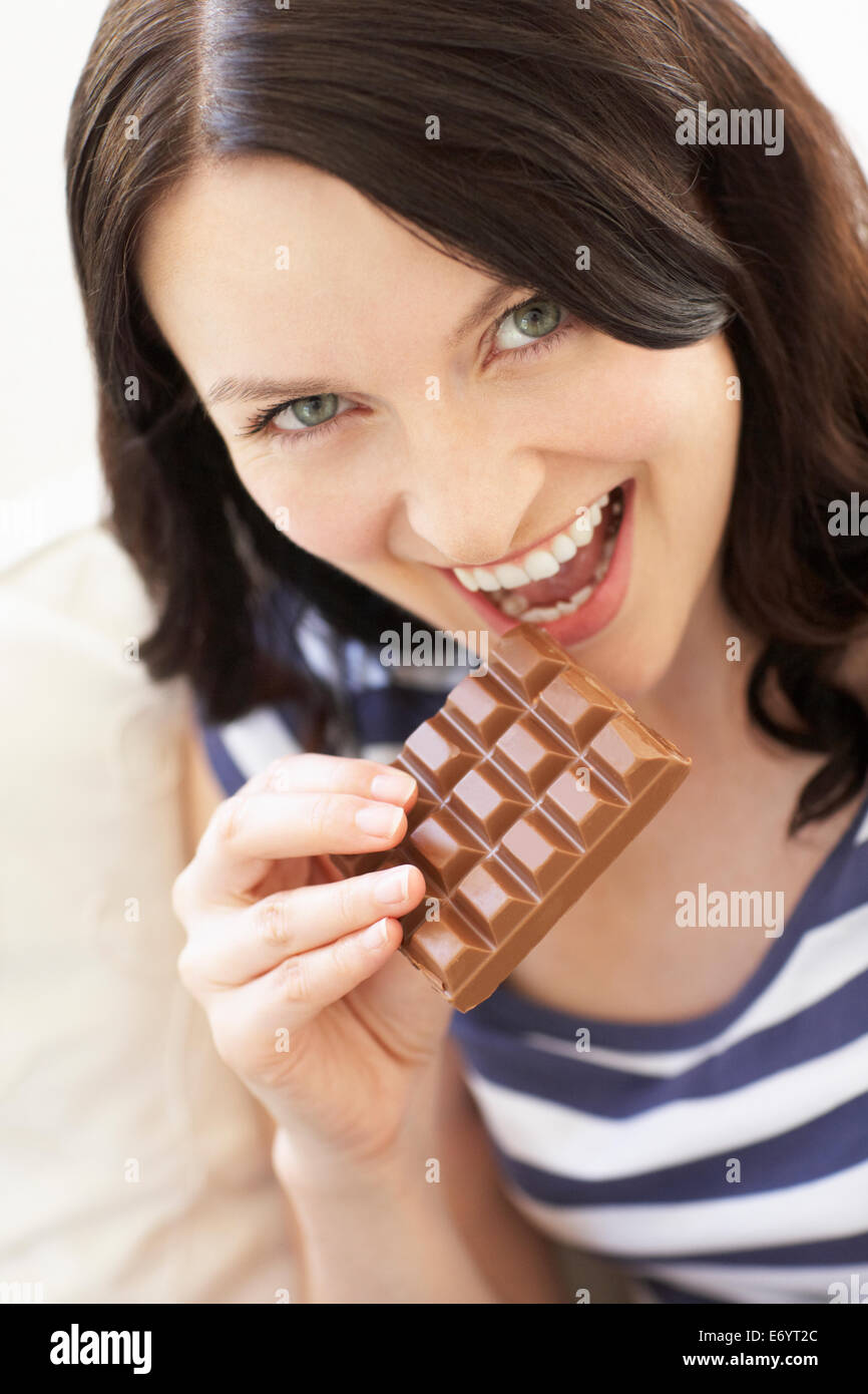 Woman relaxed eating chocolate hi-res stock photography and images - Alamy