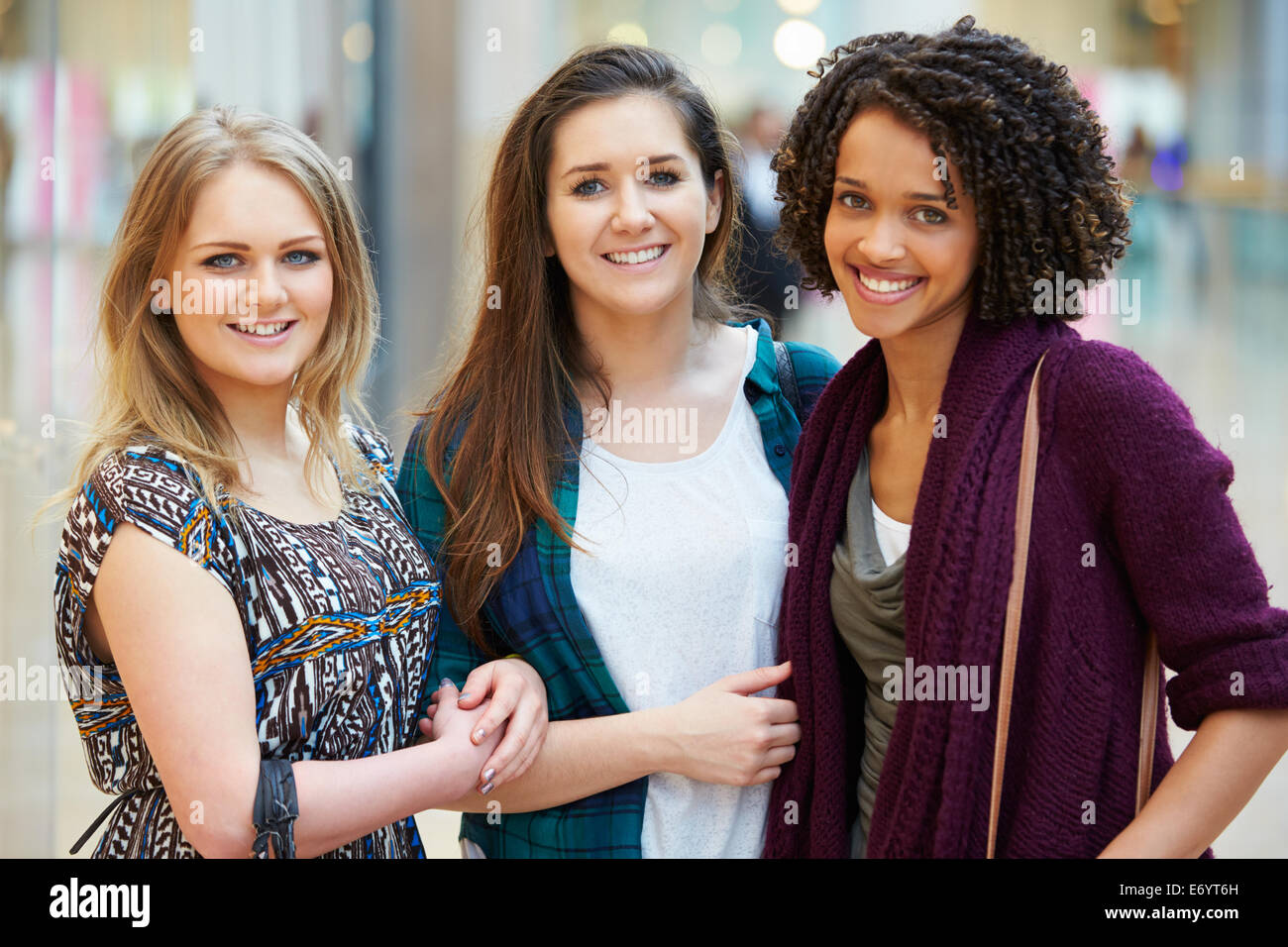 Three Female Friends Shopping In Mall Together Stock Photo - Alamy