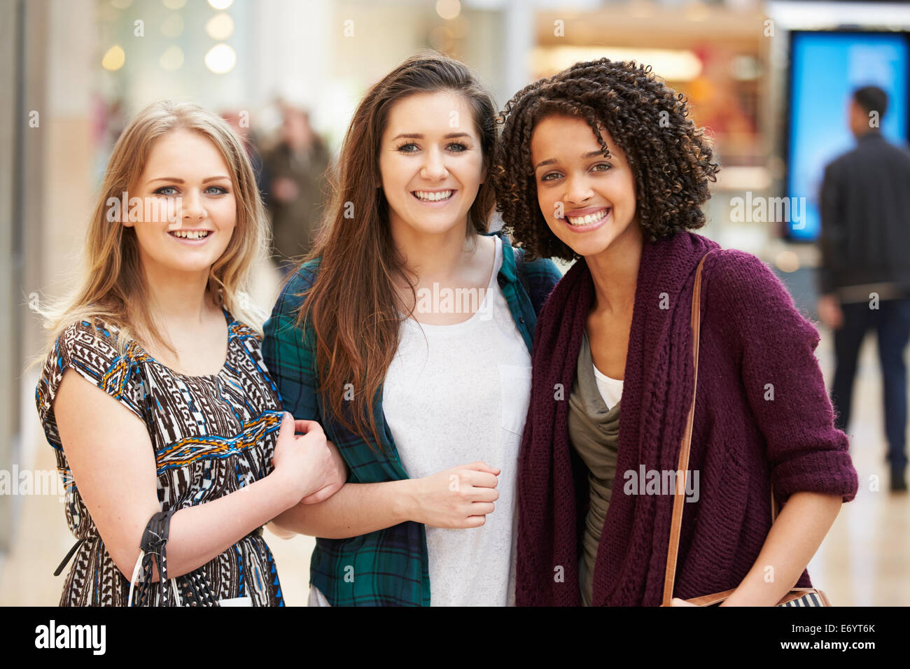 Three Female Friends Shopping In Mall Together Stock Photo - Alamy