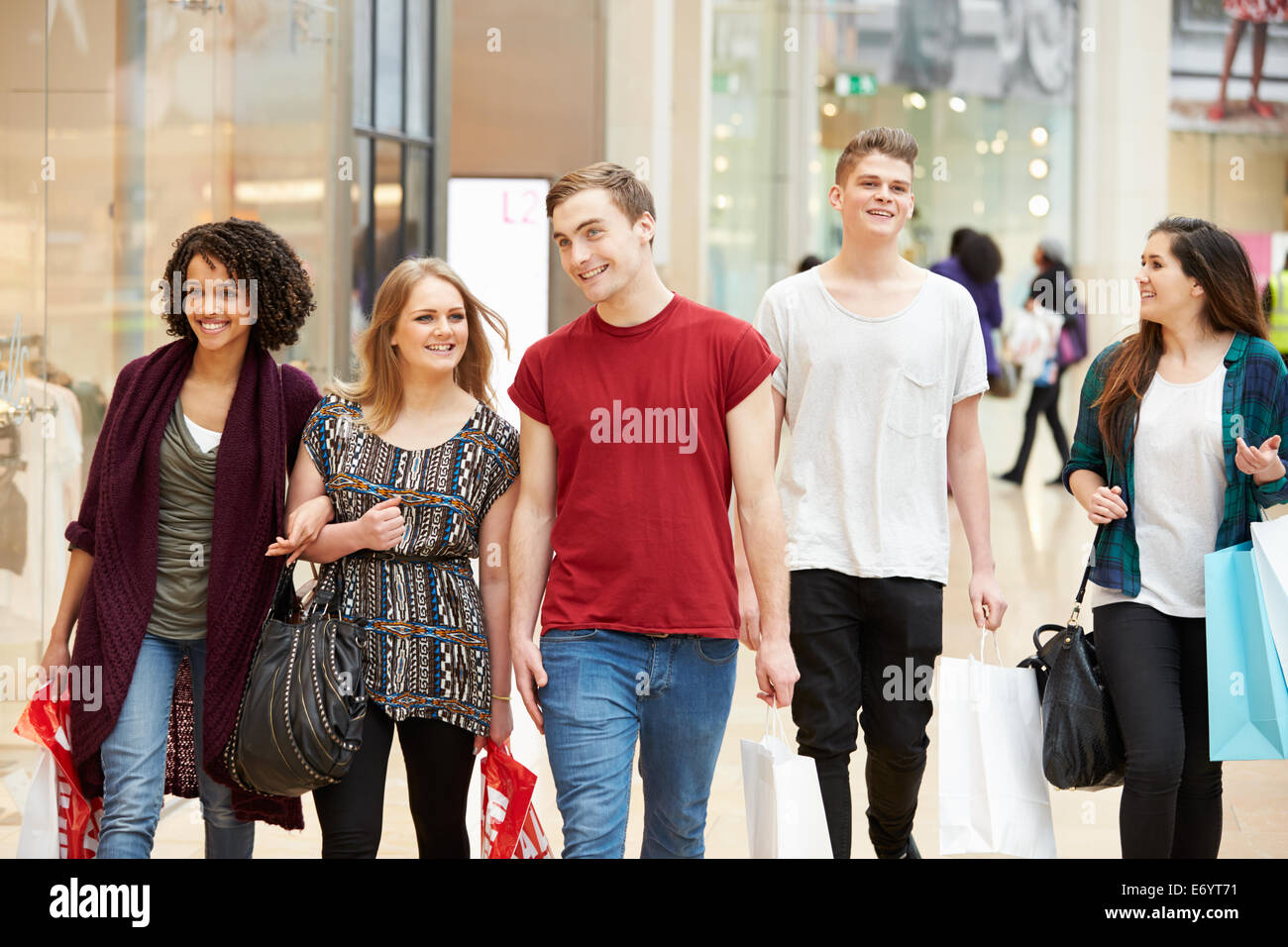 Group Of Young Friends Shopping In Mall Together Stock Photo - Alamy