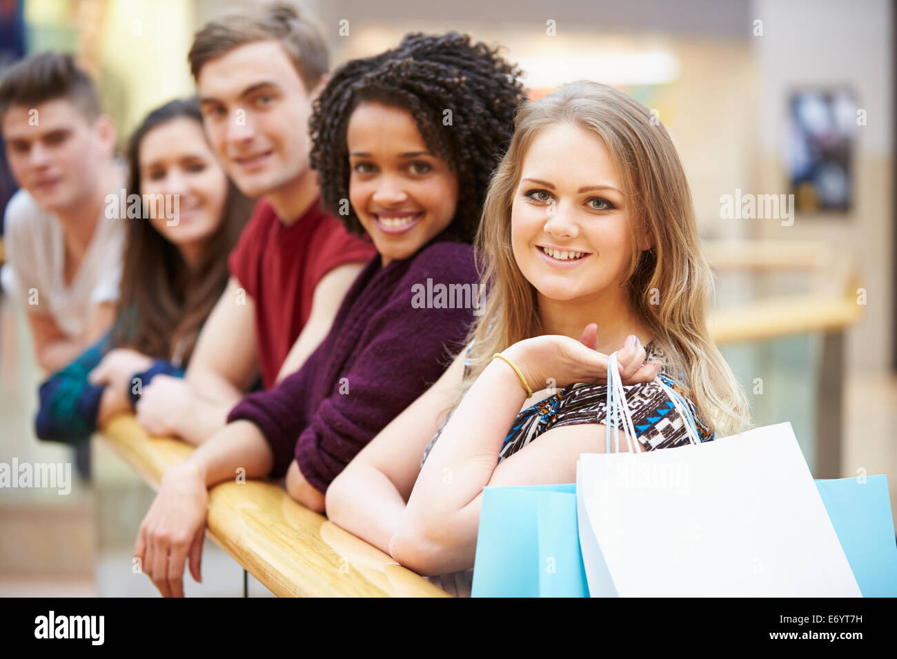 Group Of Young Friends Shopping In Mall Together Stock Photo - Alamy
