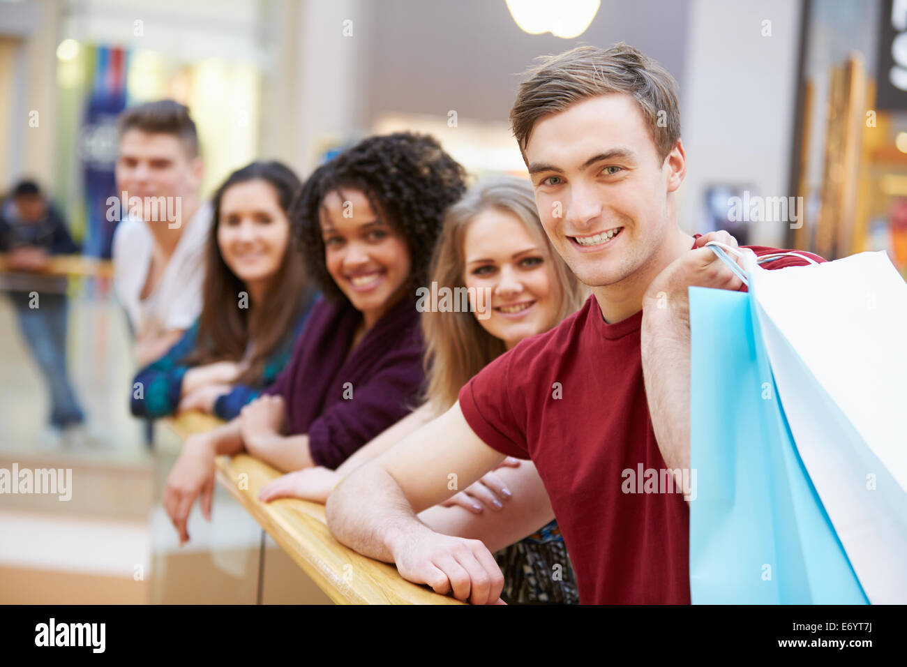 Group Of Young Friends Shopping In Mall Together Stock Photo - Alamy