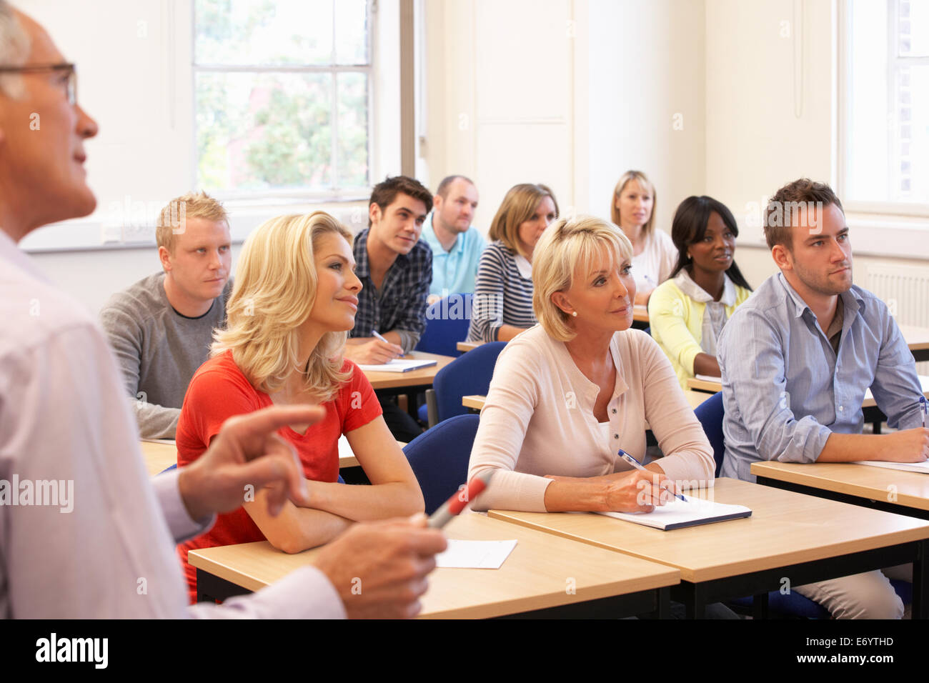 Senior tutor teaching class Stock Photo - Alamy