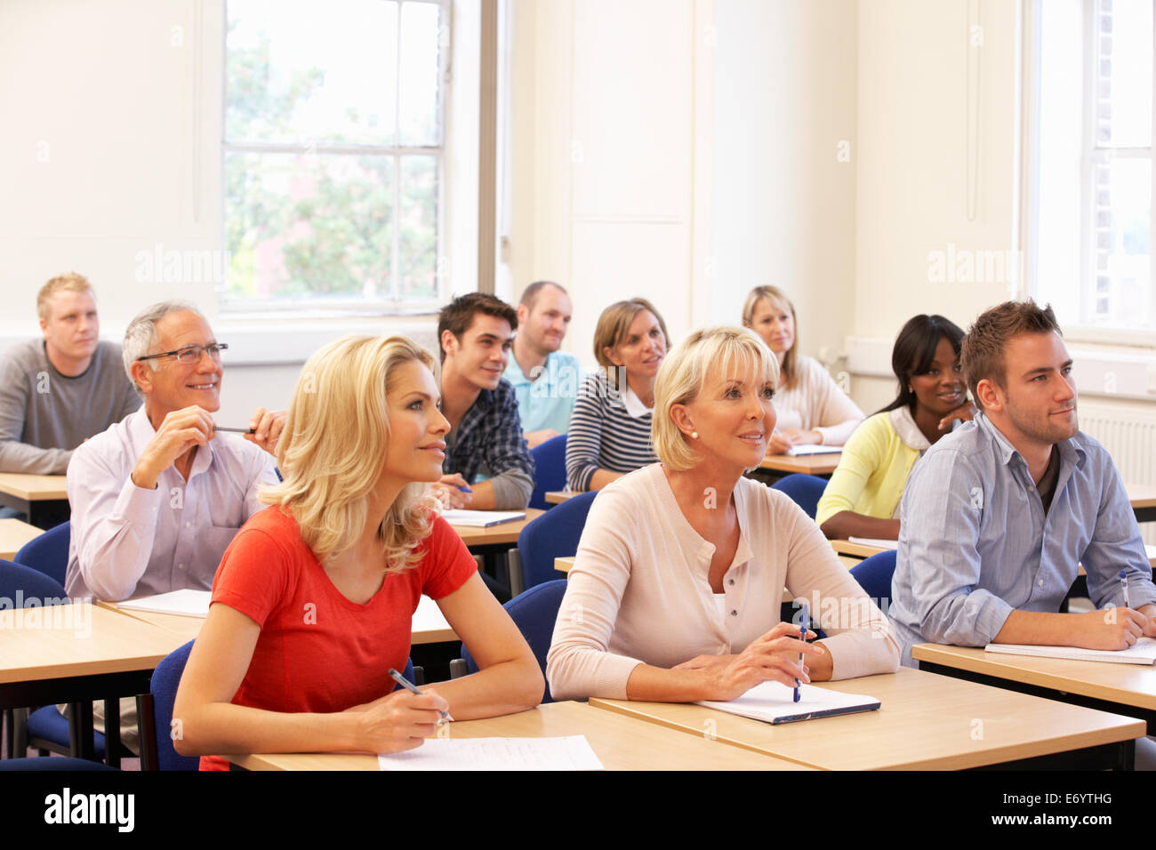 Mixed group of students in class Stock Photo - Alamy