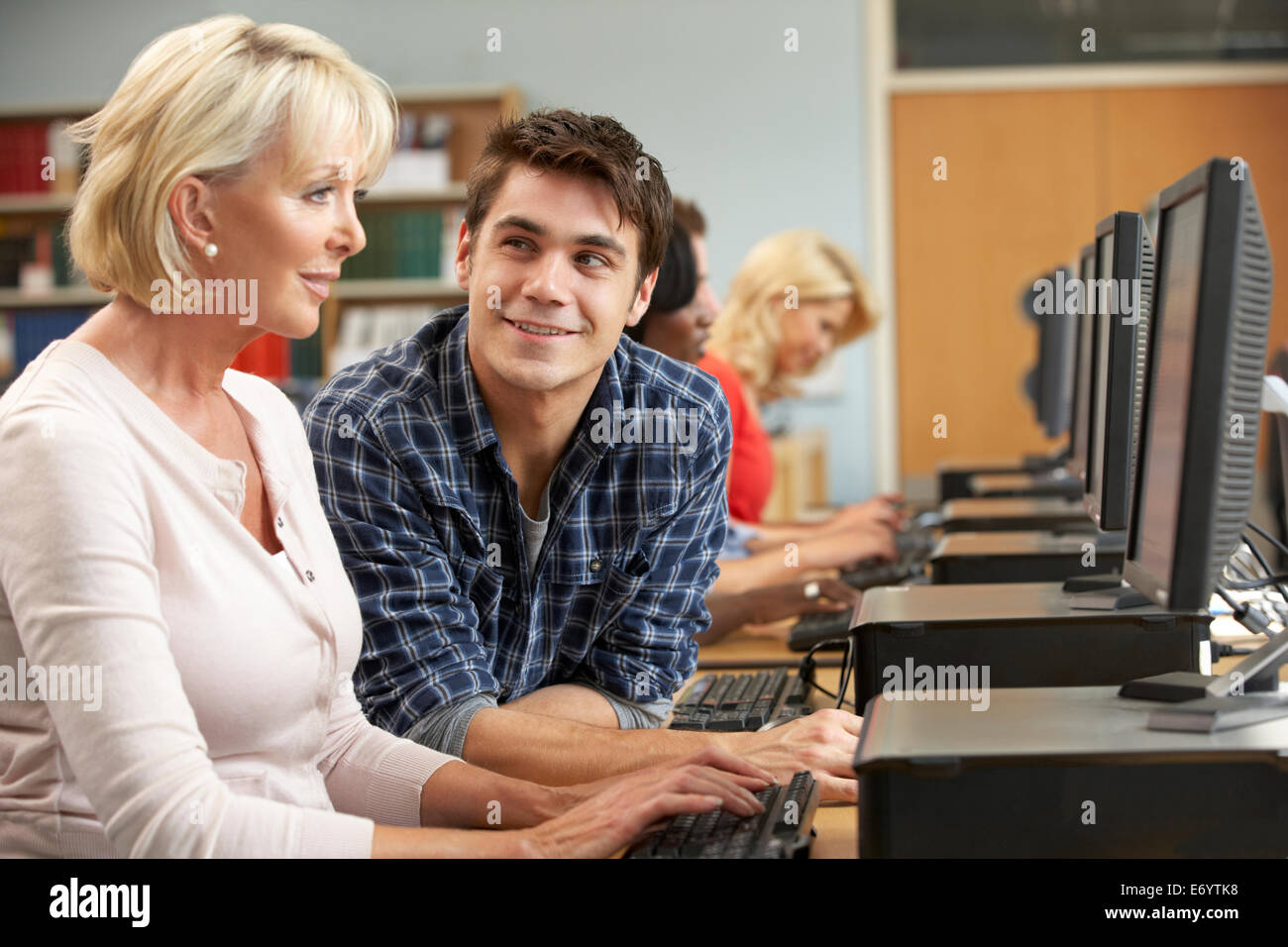 Older students helping younger students hi-res stock photography and ...