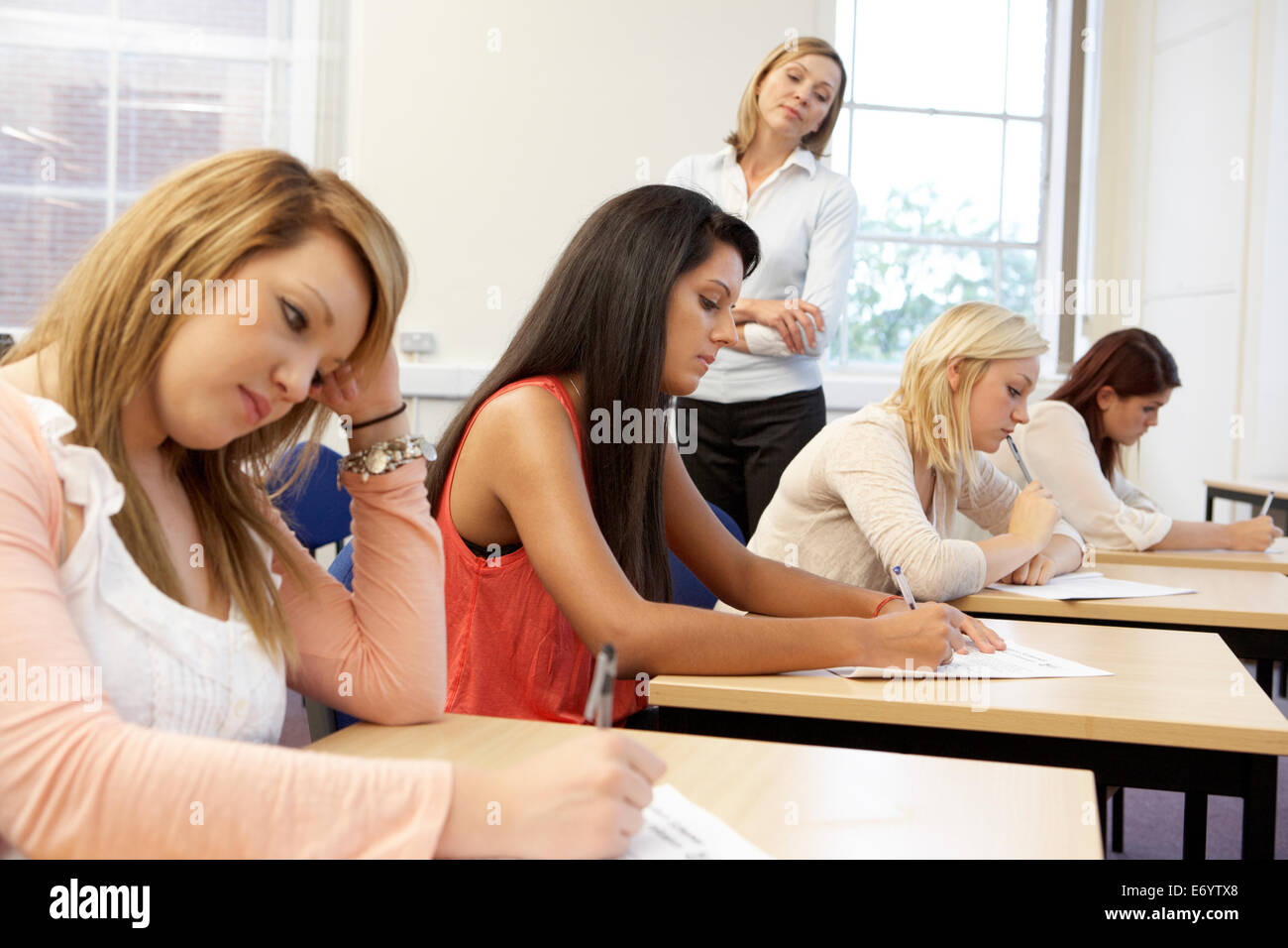Students and tutor in exam Stock Photo - Alamy