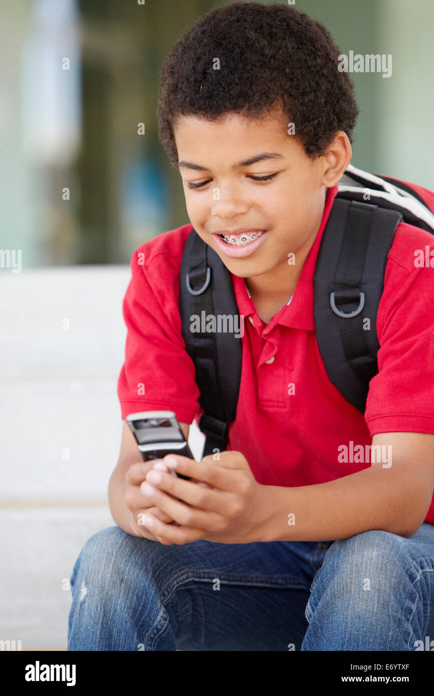 Pre teen boy with phone at school Stock Photo - Alamy