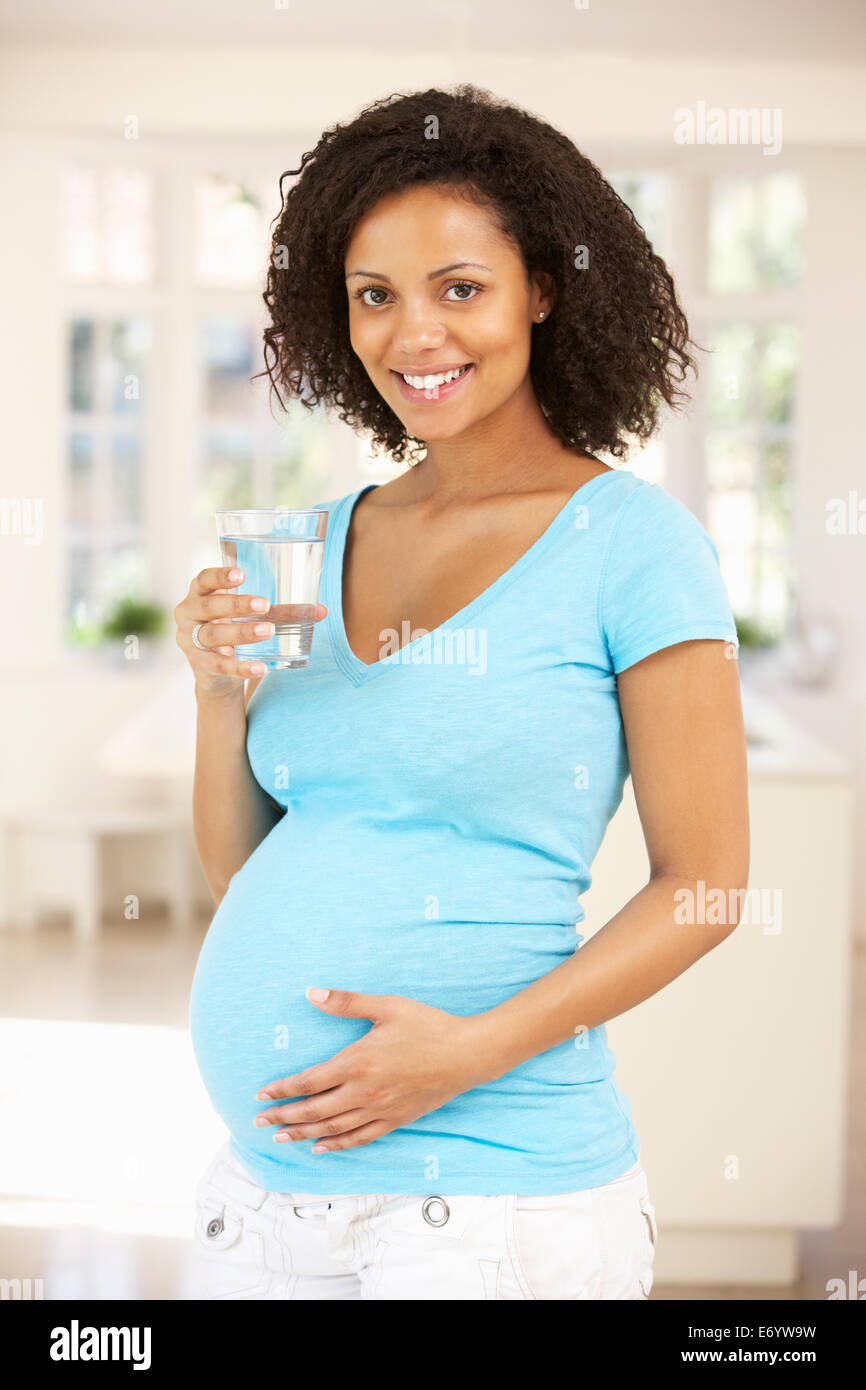 Pregnant woman drinking water Stock Photo - Alamy