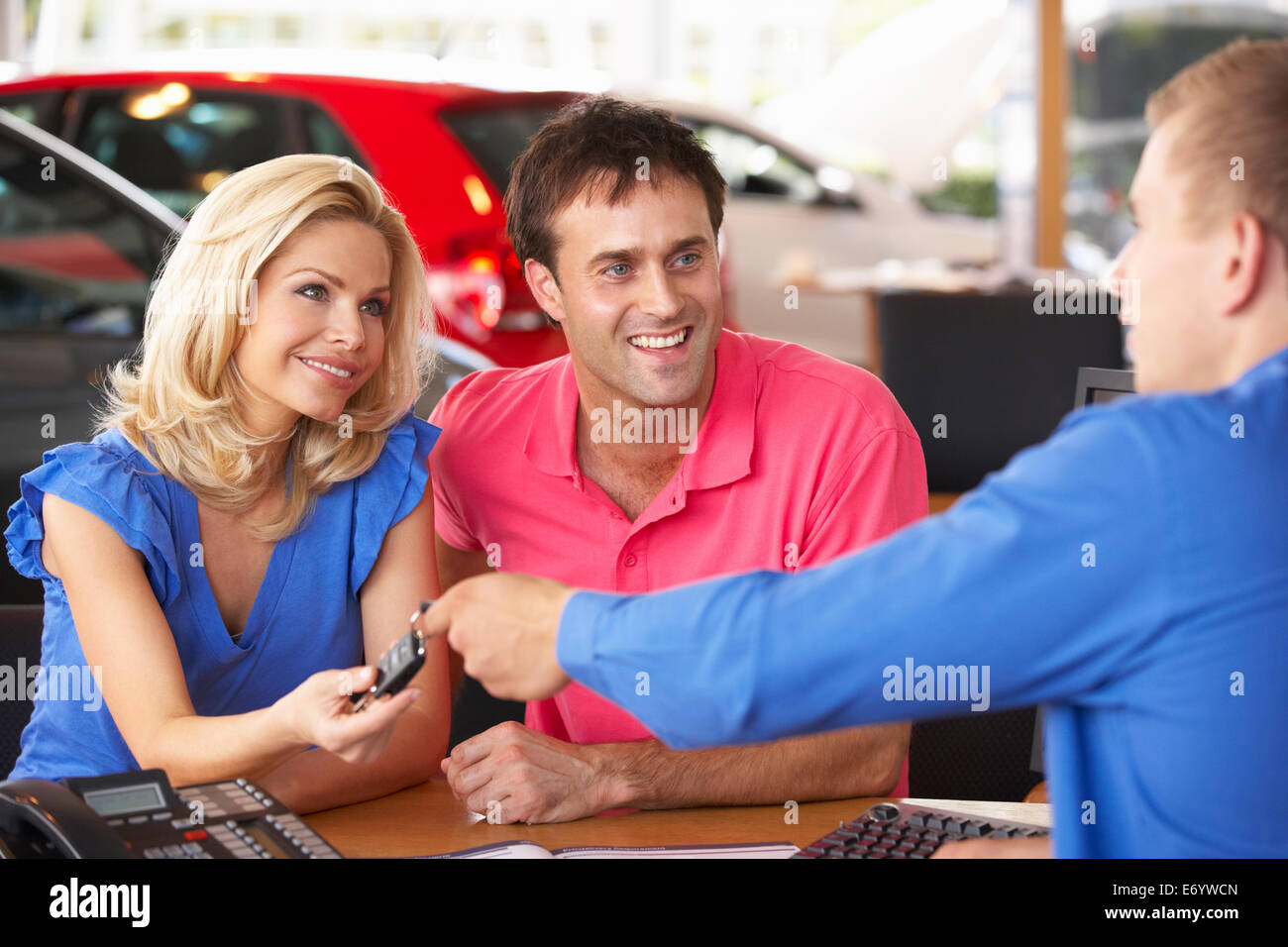 Couple buying new car Stock Photo - Alamy