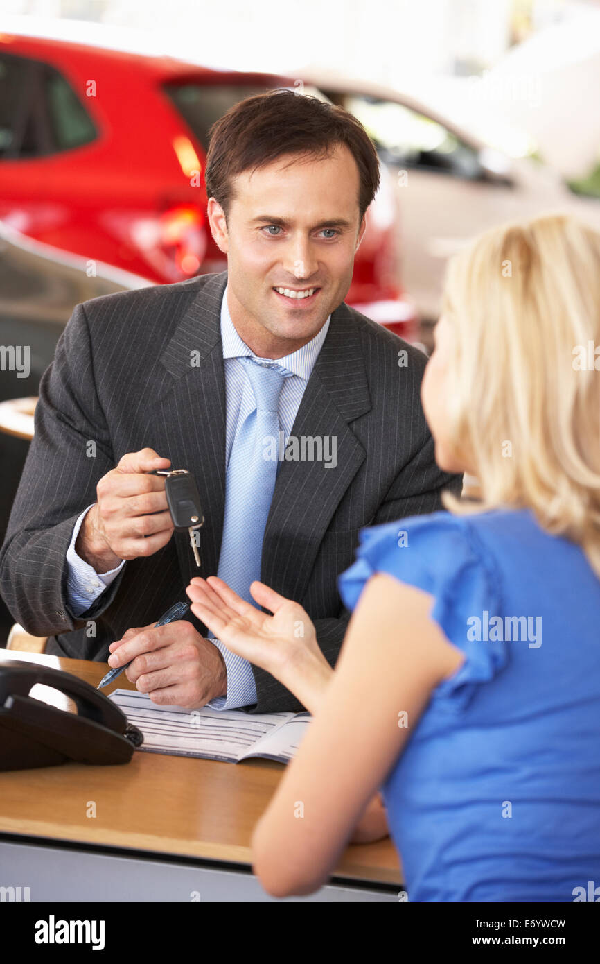 Man working in car showroom Stock Photo - Alamy