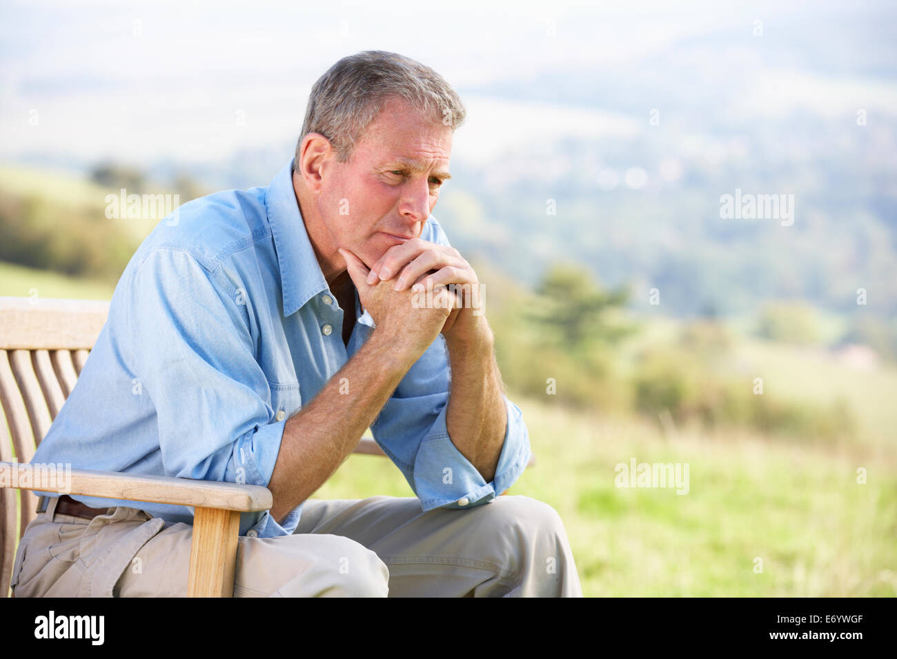 Senior man sitting outdoors Stock Photo - Alamy