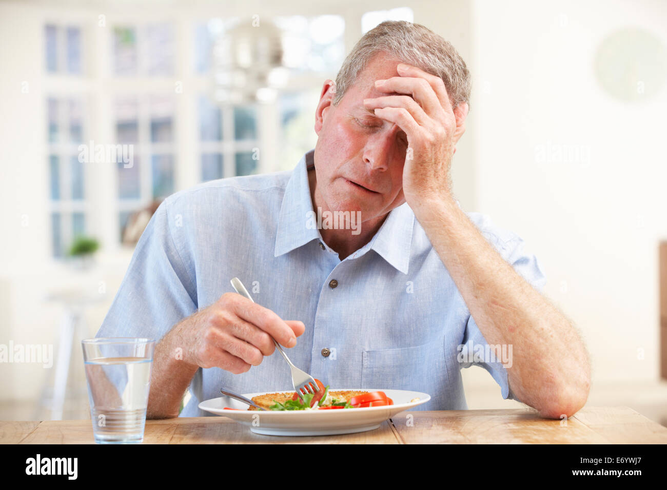 Sick older man trying to eat Stock Photo - Alamy