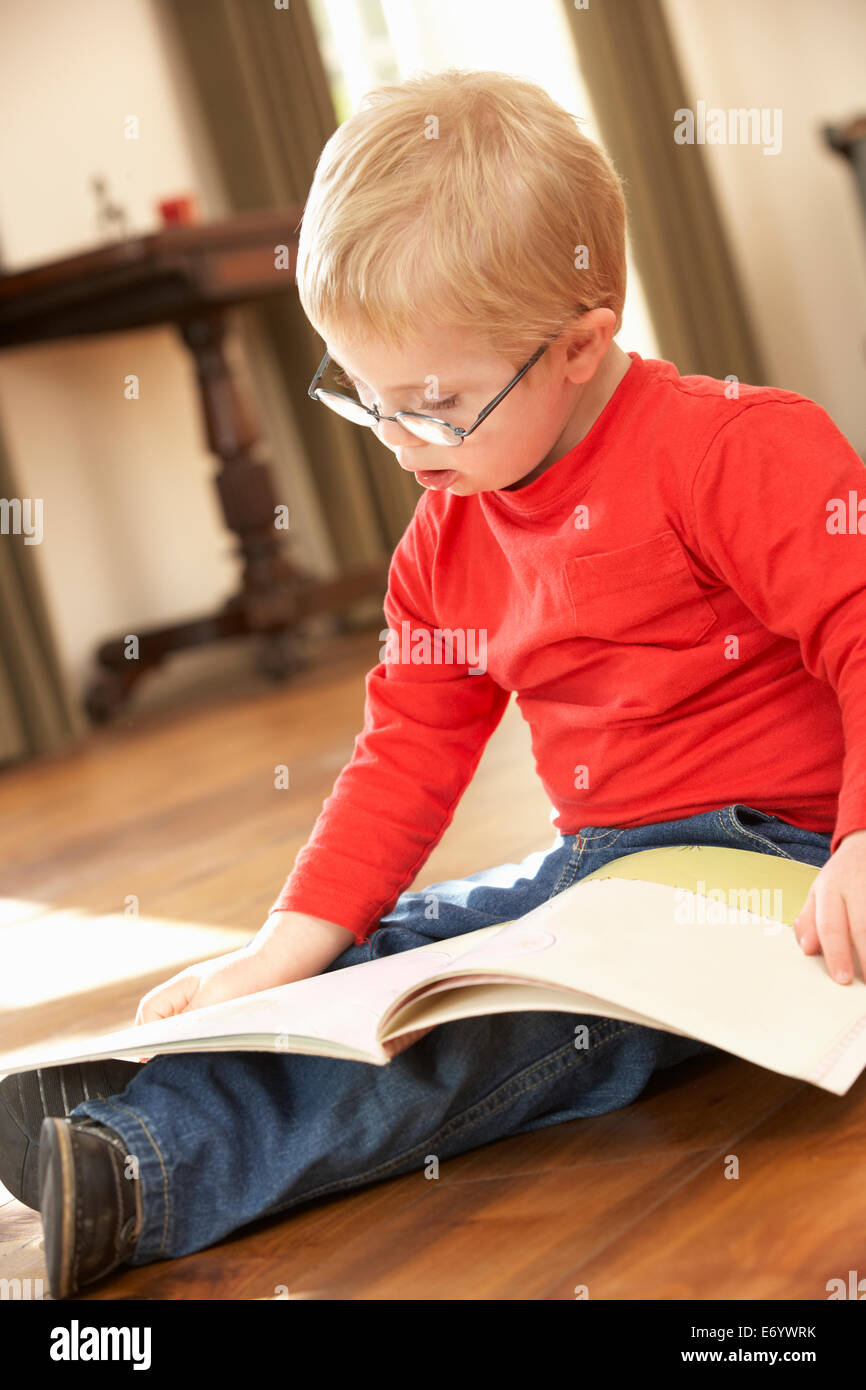 4 year old boy with Downs Syndrome reading Stock Photo - Alamy