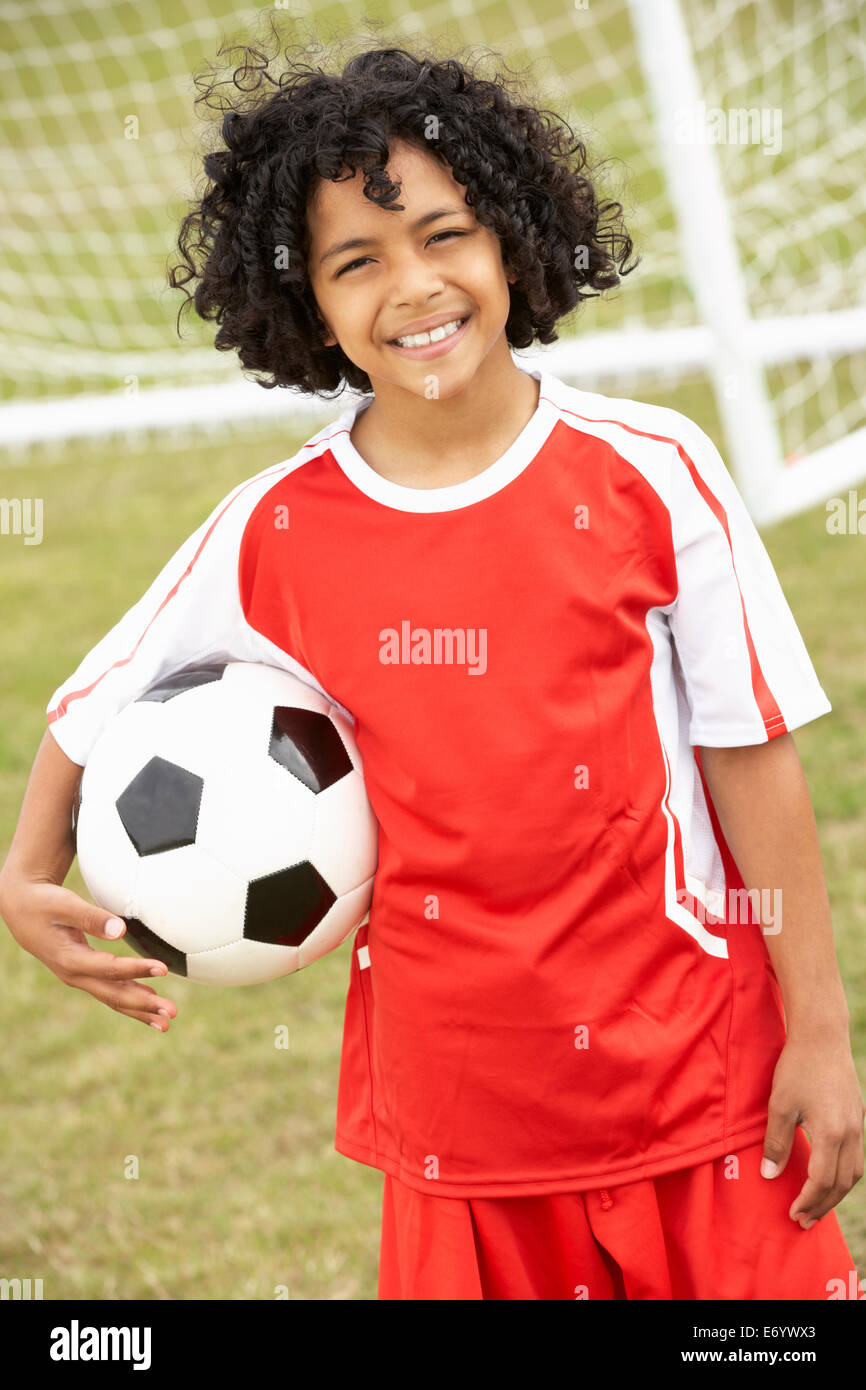 Portrait boy in football kit with ball Stock Photo - Alamy