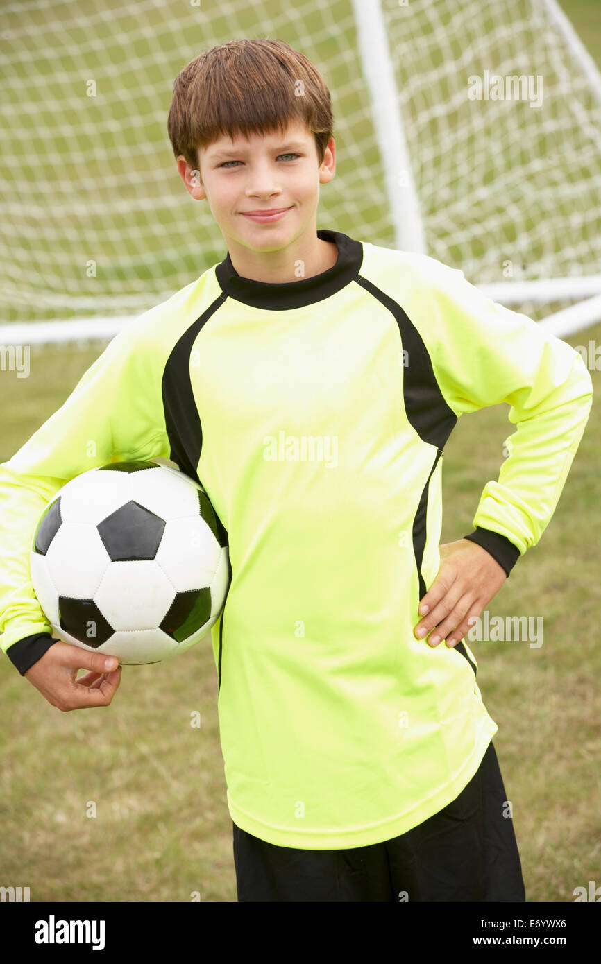 Portrait boy in goalkeeper's kit with ball Stock Photo - Alamy