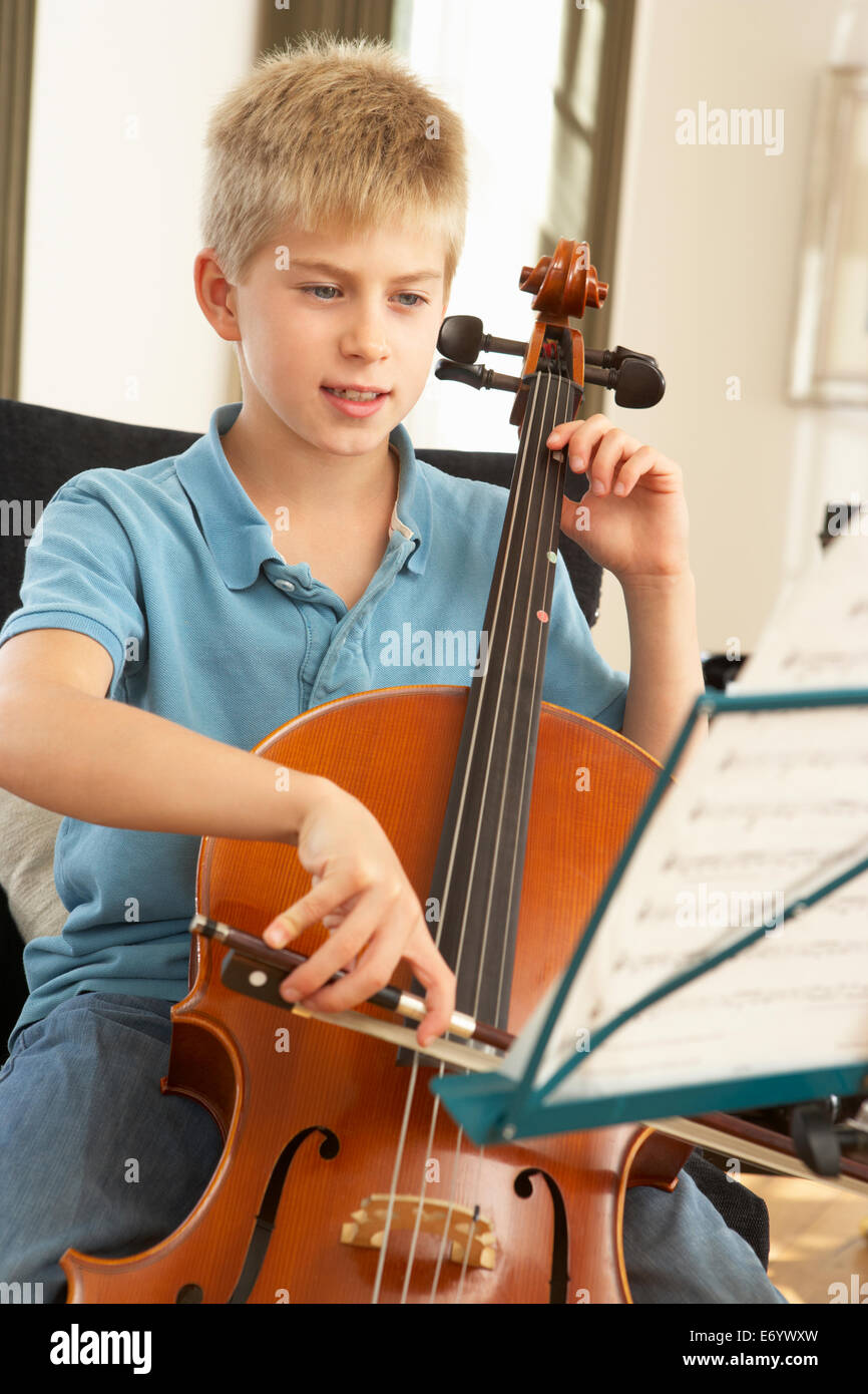 Boy playing cello at home Stock Photo - Alamy