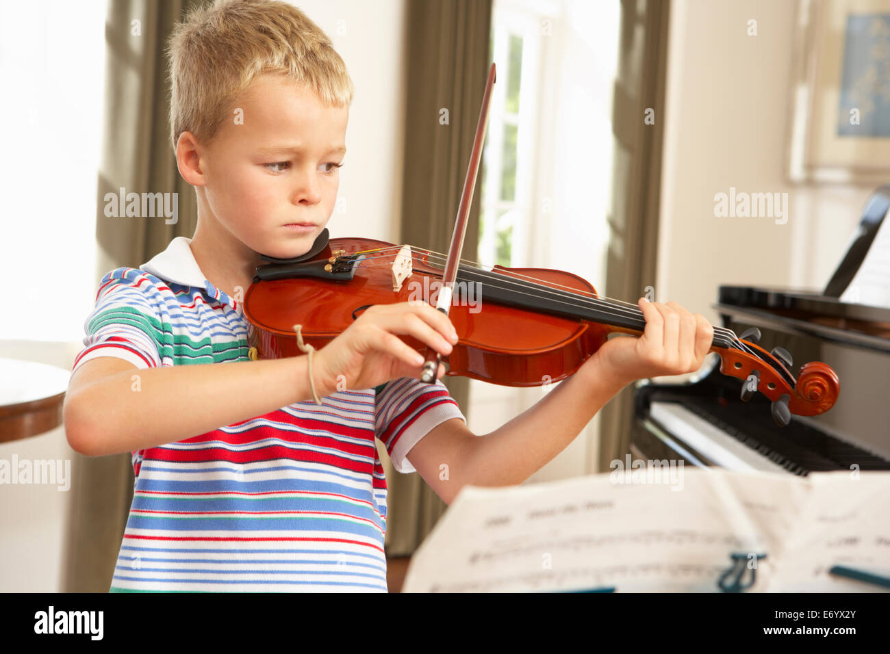 Young boy playing violin at home Stock Photo - Alamy