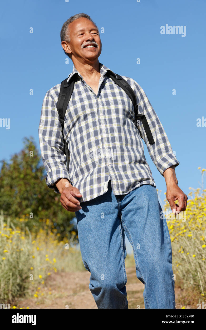 Senior man on country hike Stock Photo - Alamy